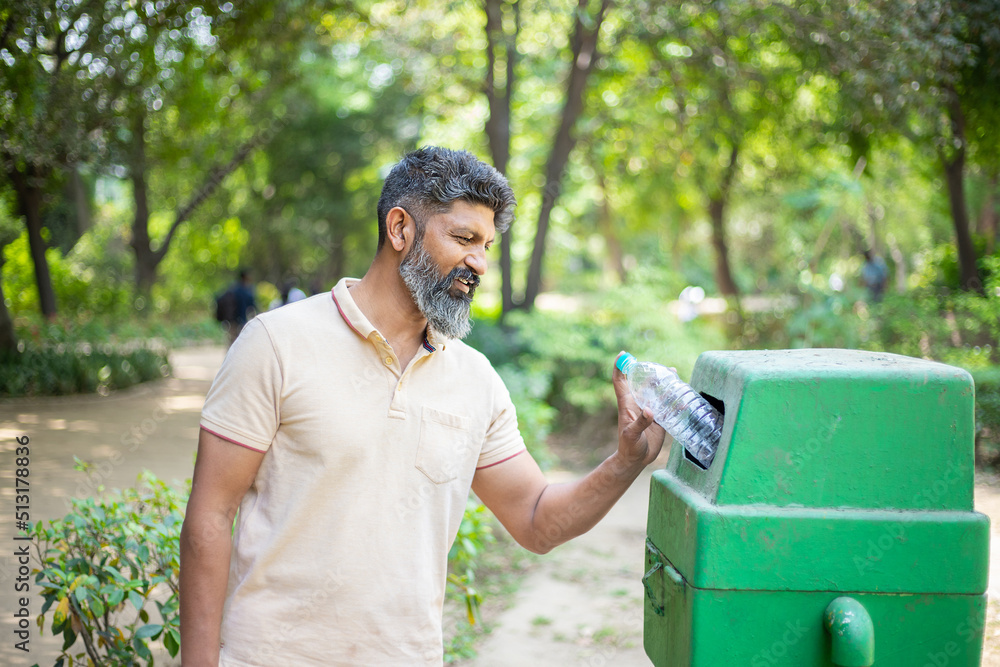 Happy Indian man throw empty litter in recycling bin, Asian male drop ...