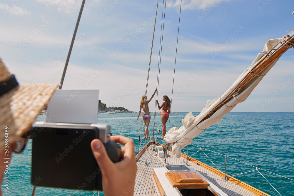 Two happy friends in bikinis on holiday cruise together having their ...