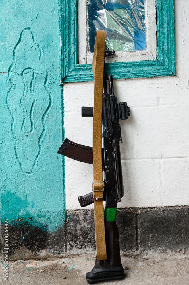 The Ukrainian soldier's combat military assault rifles AK 74 is leaning ...
