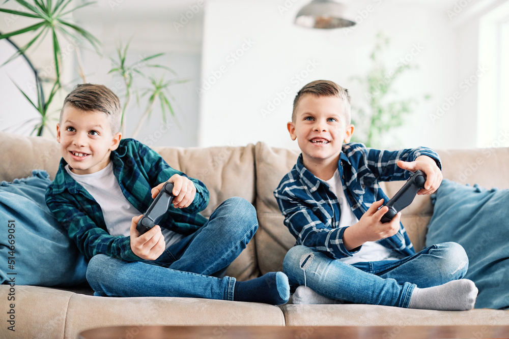 child brother friend having fun playing console laughing happy kid ...