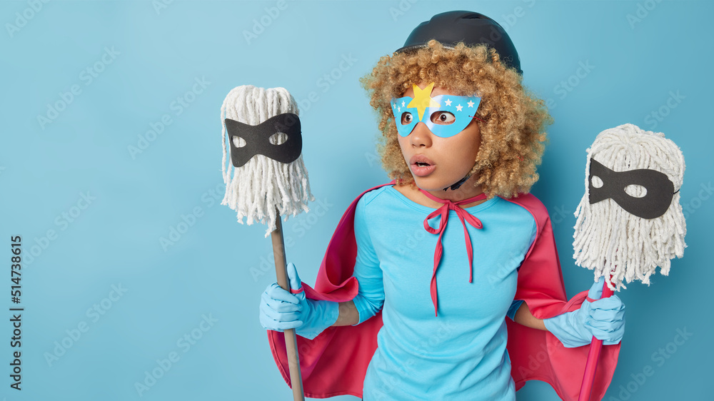 Shocked female model dressed in superhero costume feels brave stares ...