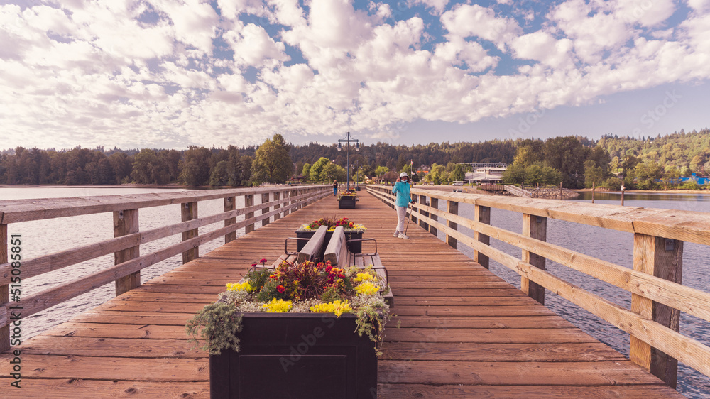 Cloudy skies over public pier at Rocky Point Park, Port Moody, BC - a ...