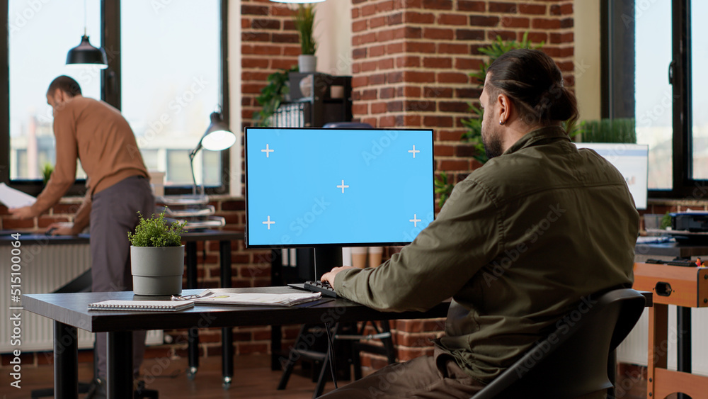 Office employee typing on computer with greenscreen, working with ...