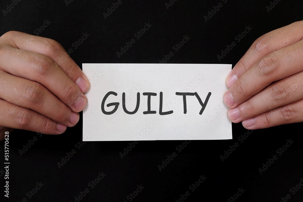 Guilty verdict concept. Criminal hands holding paper placard mug shot ...