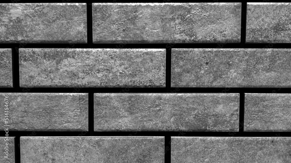 Brickwork made of bricks made to look like natural stone. Dark gray ...