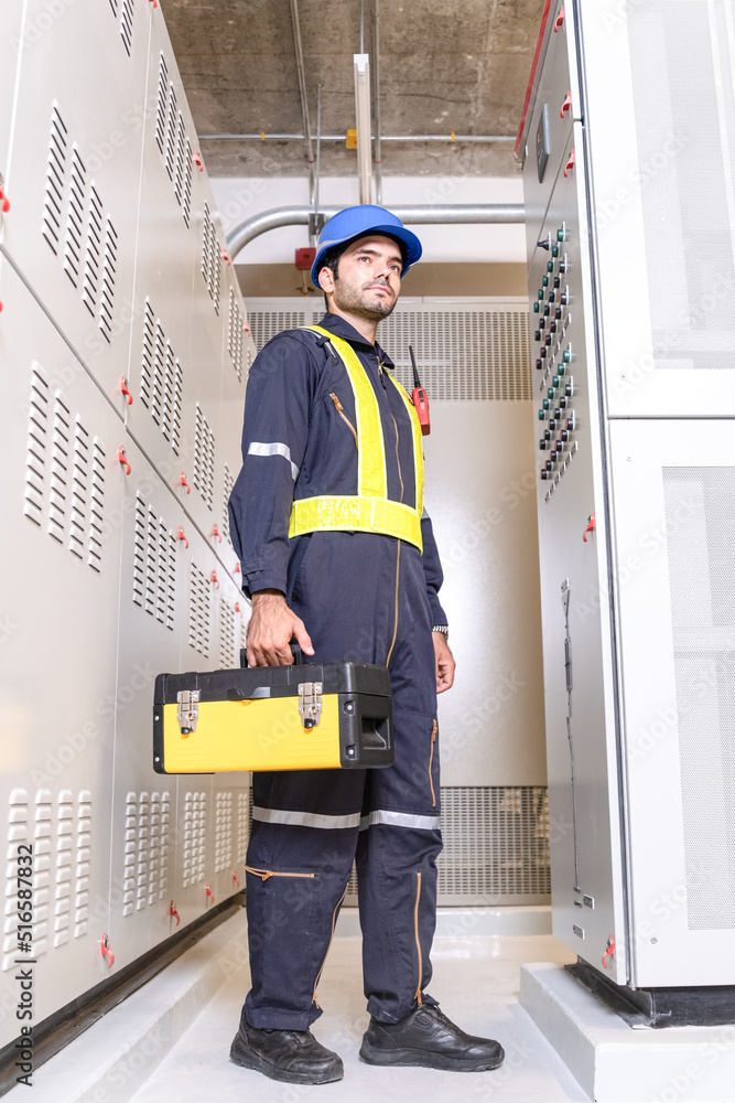 Maintenance engineer inspect relay protection system with laptop tablet ...