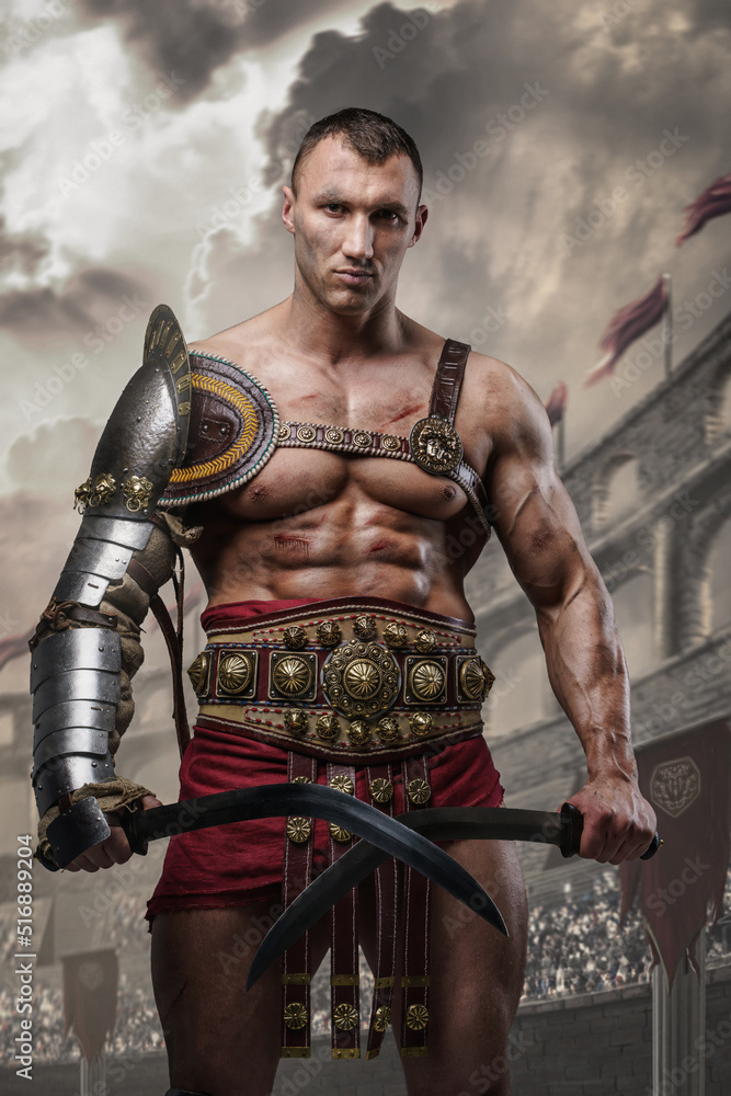 Portrait of handsome gladiator with dual swords dressed in light armor ...