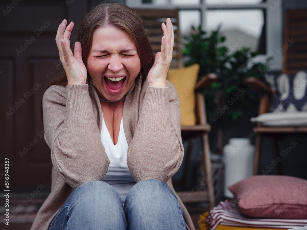 middle aged depressed woman sitting on porch. She feeling sad and ...