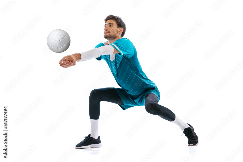 Portrait of young concentrated man, volleyball player in motion ...