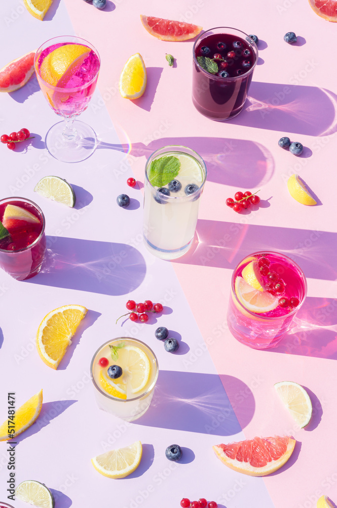 Colorful drink cocktail with fruits on a pastel pink and purple ...