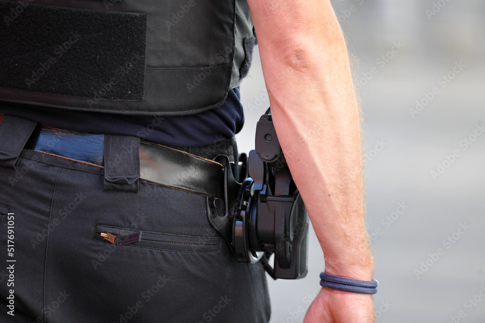 Partial view of a male police officer walking on patrol in Berlin-City ...