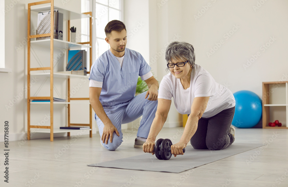 Foto de Stock Professional physiotherapist helping old lady during ...
