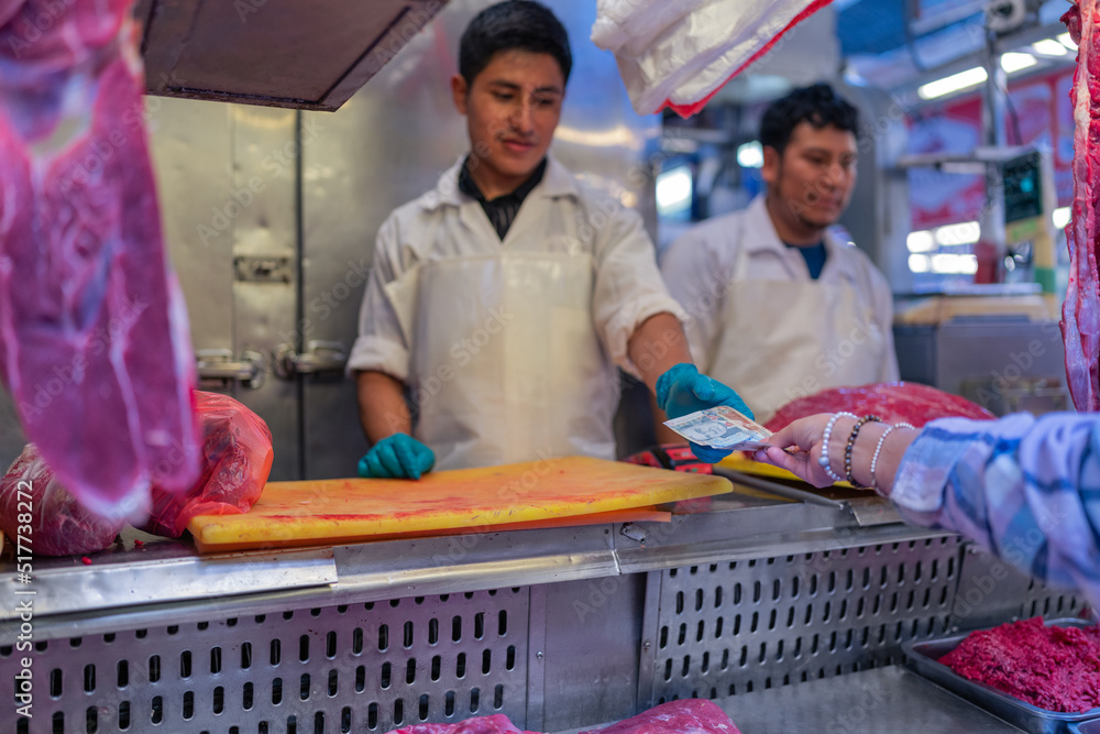 Butcher receiving payment from customer Stock Photo | Adobe Stock