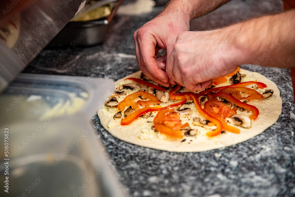 hand of chef baker making pizza at kitchen. The process of making pizza ...