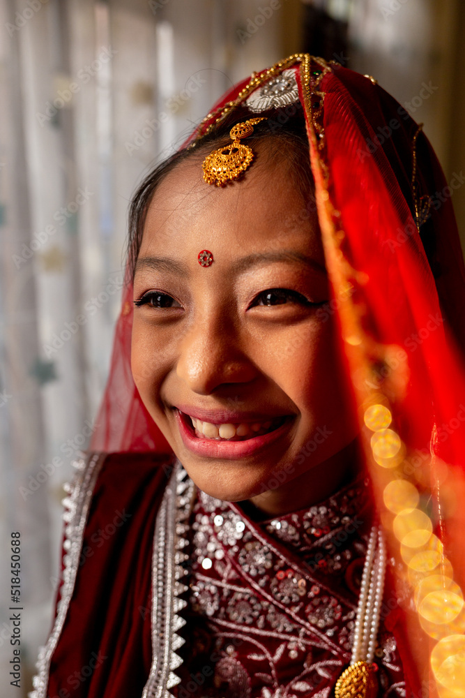 Nepali girl in traditional attire smiling Stock Photo | Adobe Stock