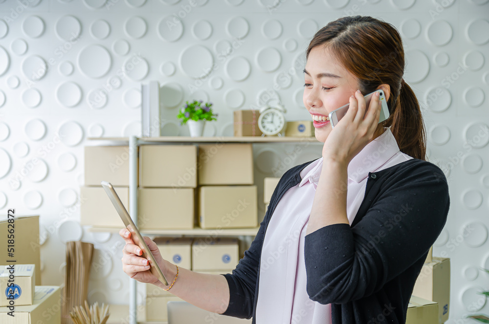 beautiful asian woman smile and check list product by tablet and ...