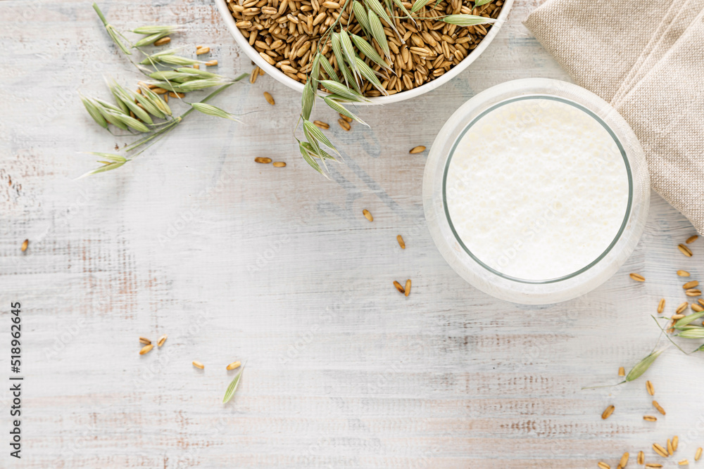 Oat milk. Healthy vegan non dairy alternative oat milk drink in a glass ...