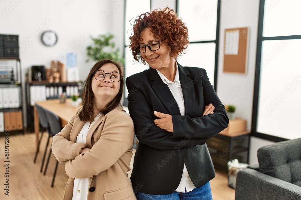 Group of two women working at the office. Mature woman and down ...