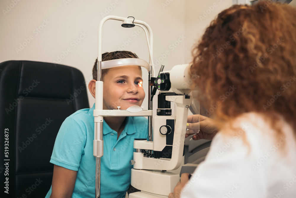 examination of a child with a slit lamp, microscope and focused light ...