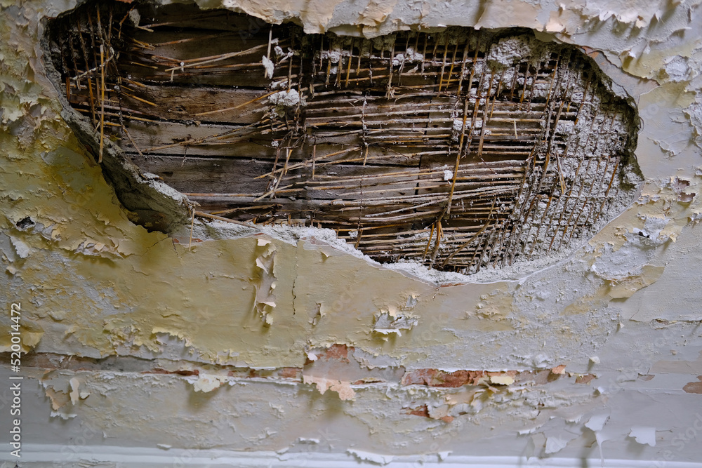 collapsing house with collapsed ceiling, cracks, concept of destruction ...