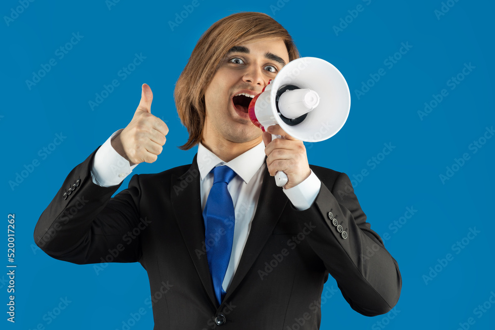 Young man using an electric megaphone. Guy with speaking-trumpet ...