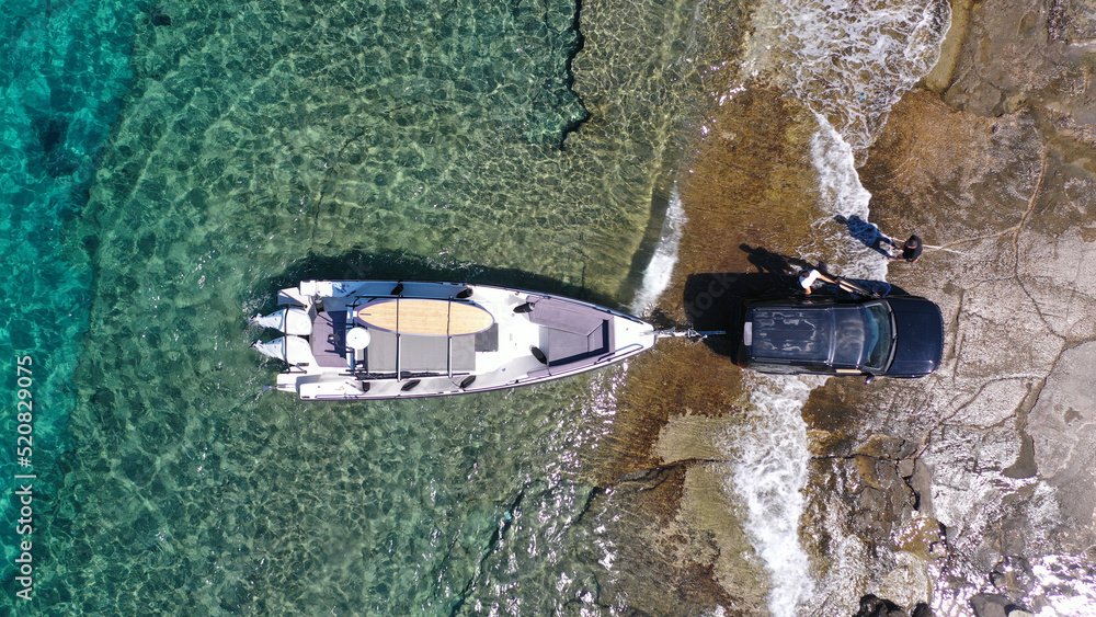 Aerial top view photo of speed boat on transport trailer being towed by ...