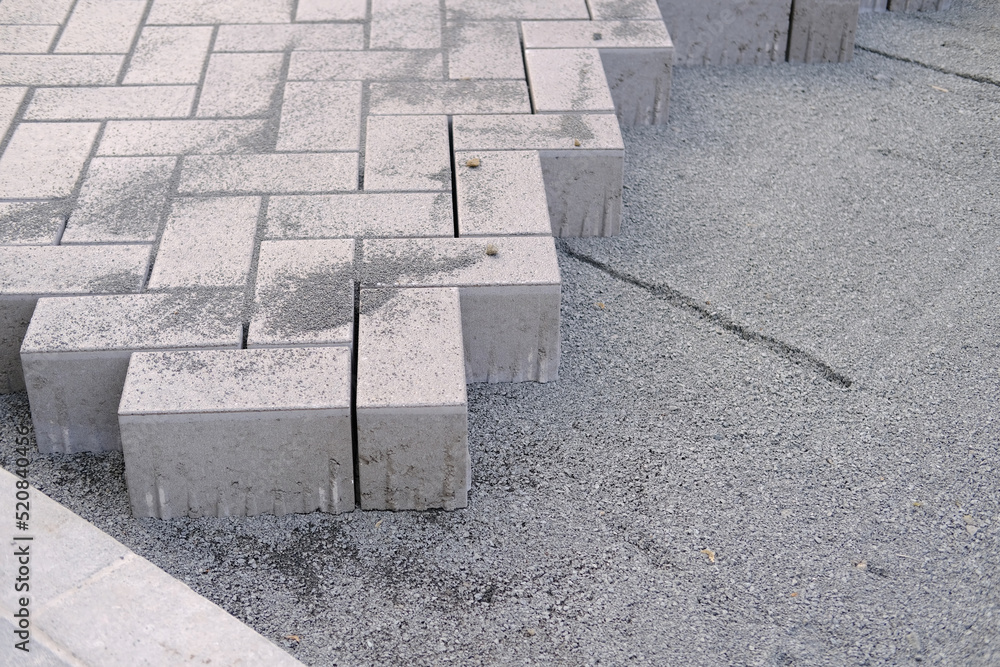 gray paving blocks on the ballast, side view, construction site of ...