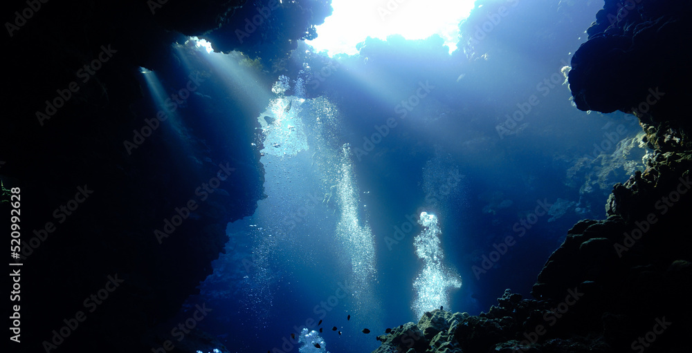 Underwater photo from a scuba dive inside caves and tunnels with rays ...