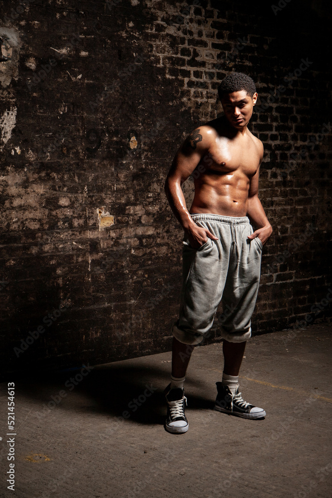 The Jock. Low key images of an athletic young man showing off his ...