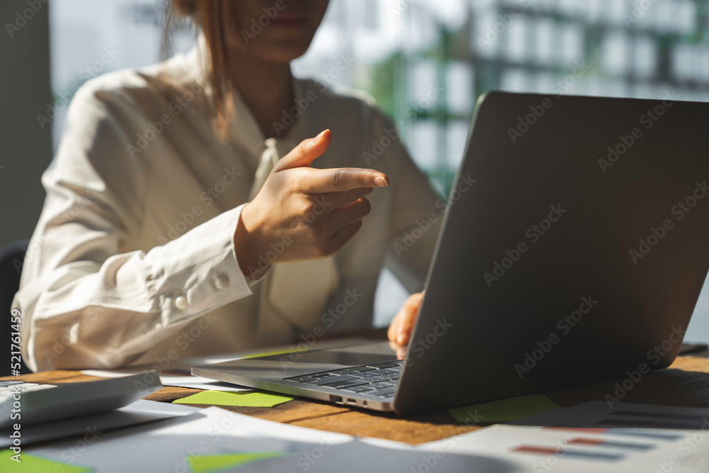 Asian businesswoman using the computer in video conferencing ...