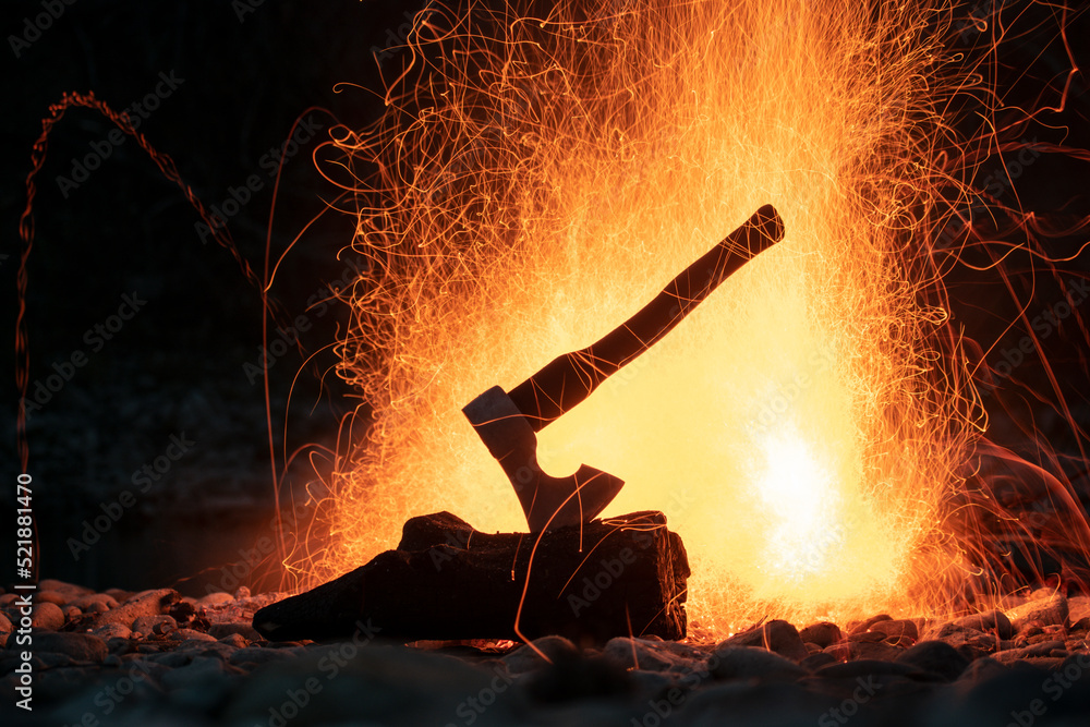 Viking ax. An ax driven into a piece of wood. Ax in the water. An ax by ...