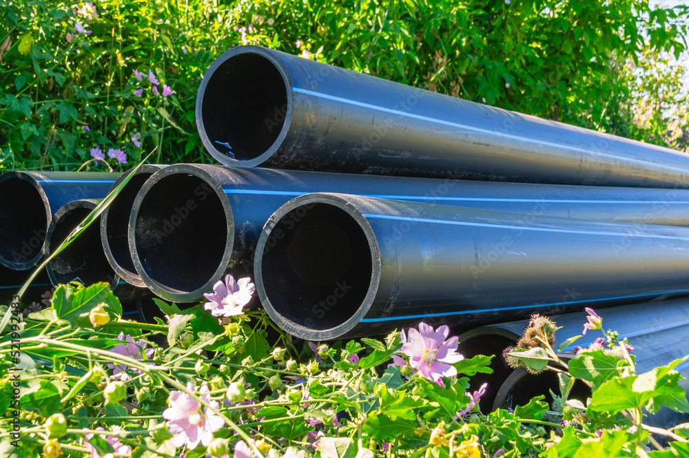 Large diameter plastic pipes for outdoor water supply. HDPE pipes lie ...