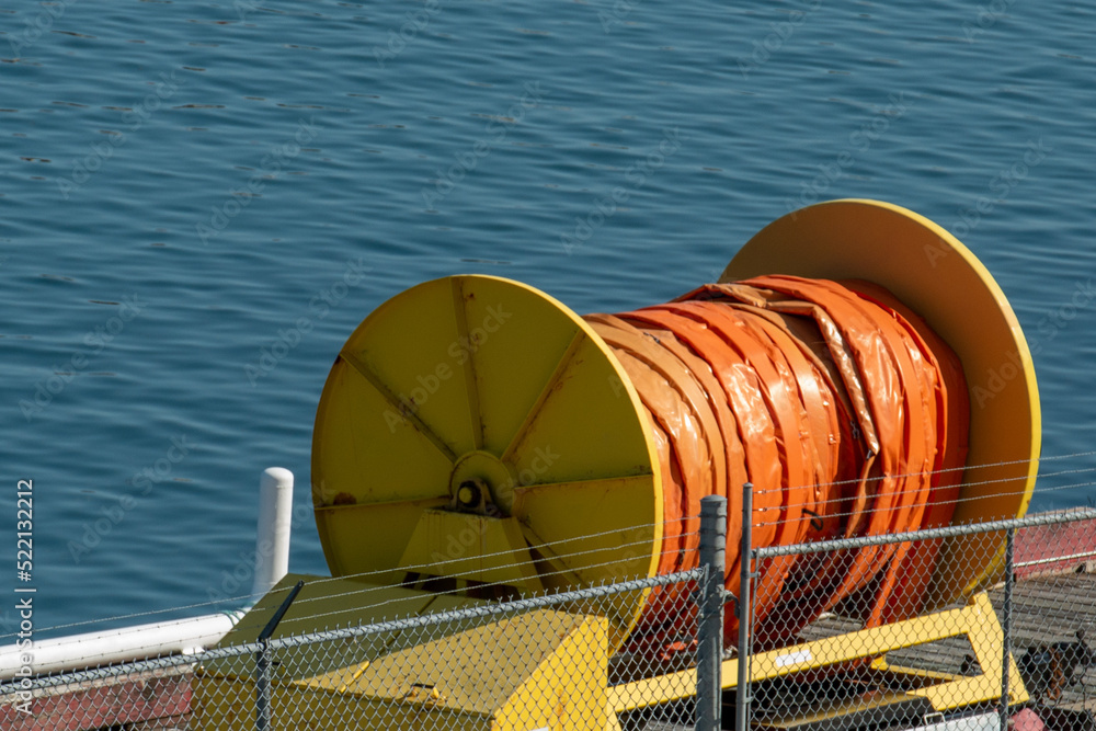 An industrial reel of orange oil sorbents spills containment boom ...