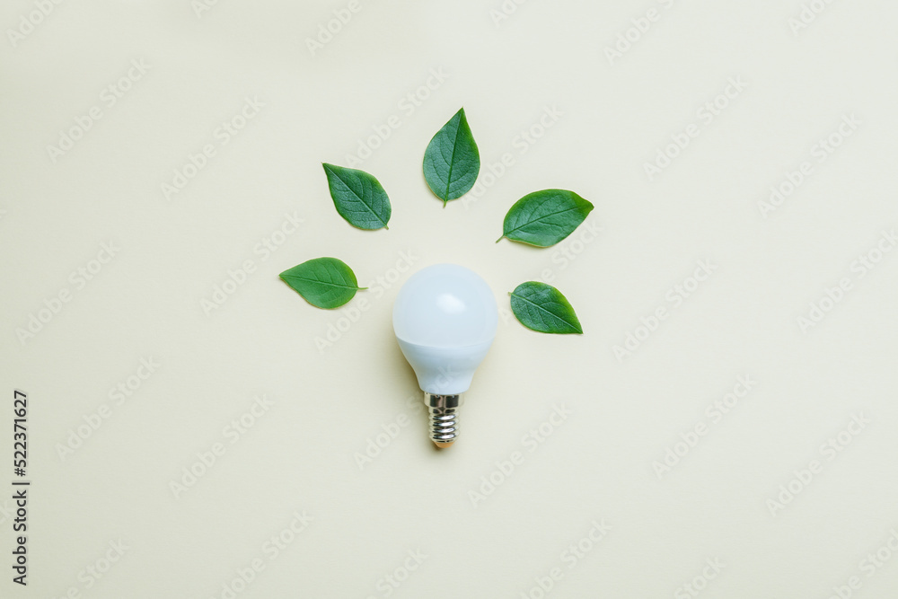 Energy saving lightbulb with green leaves background. Save energy ...