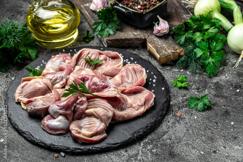 Stomachs chicken in pan. Raw uncooked chicken gizzards, stomach ...