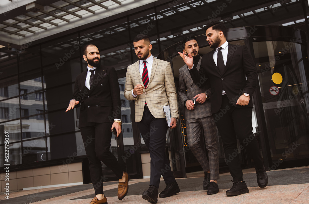 Business people outdoor meeting, A group of male businessmen in suits ...