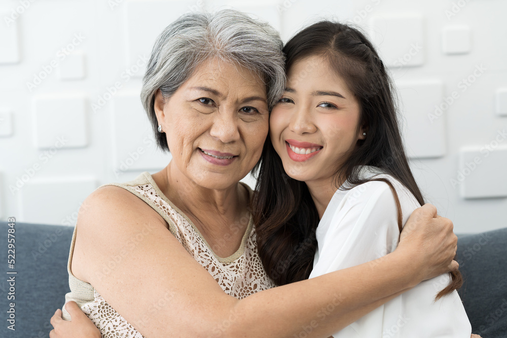 Elderly mum hugging grownup daughter at home. Close up happy older mature mother embracing young ...