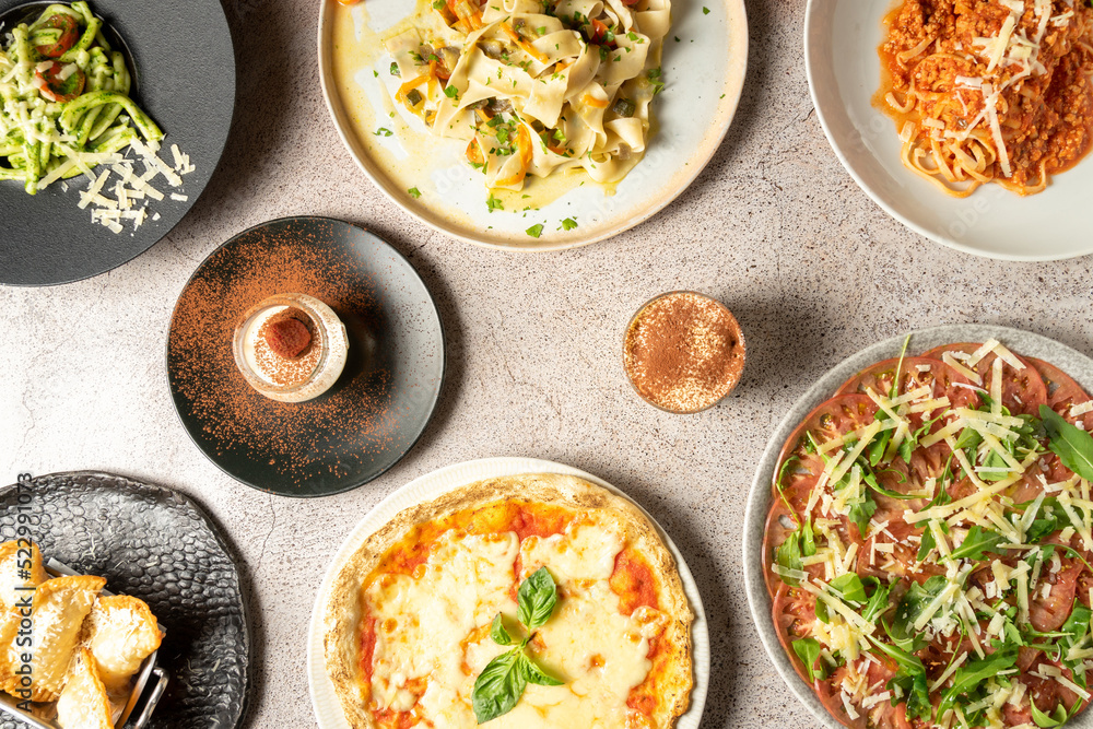 Top view of various Italian food dishes including desserts on a ...