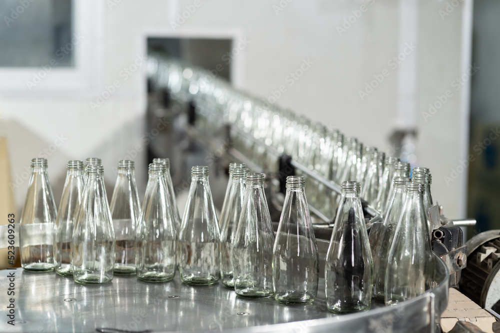 Bottles of product of fruit juice on the conveyor belt in the beverage ...