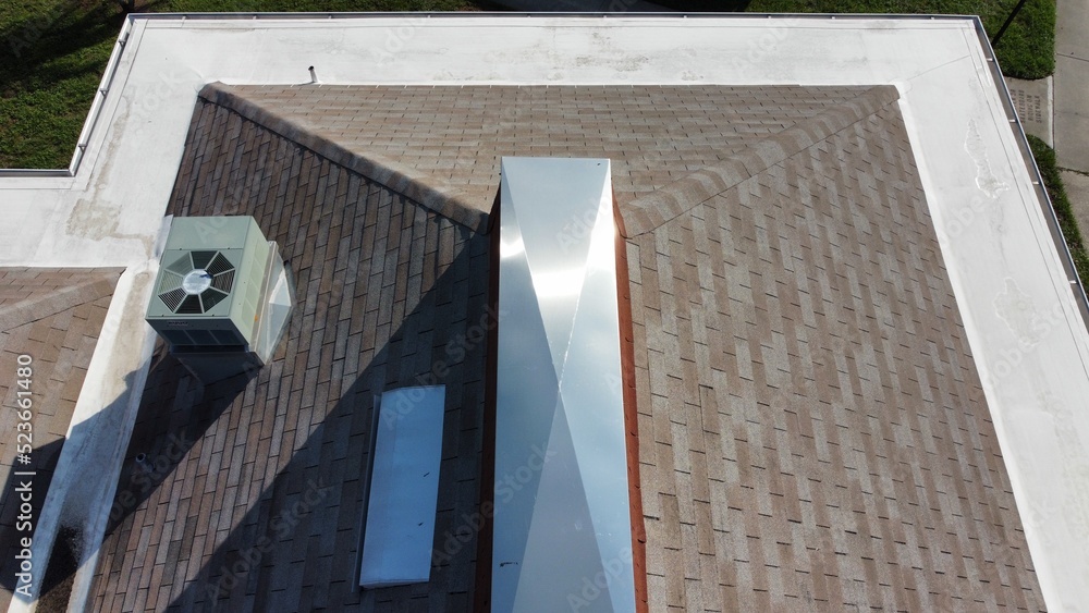 air conditioning unit on top of family house in Florida with shingle ...