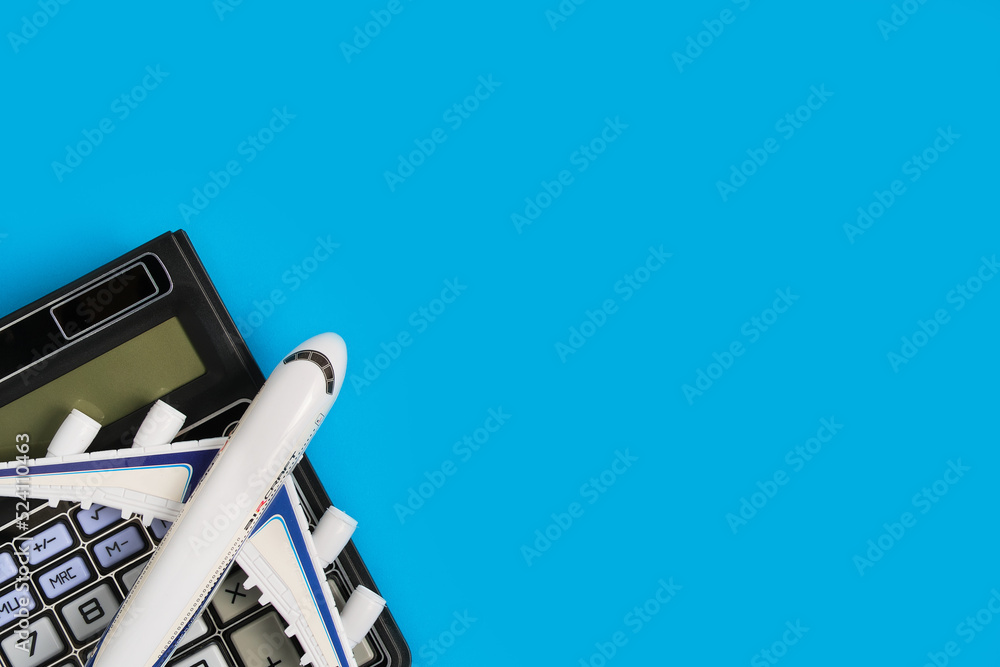 Stock-Foto „Airplane model and calculator blue background.Concept of ...