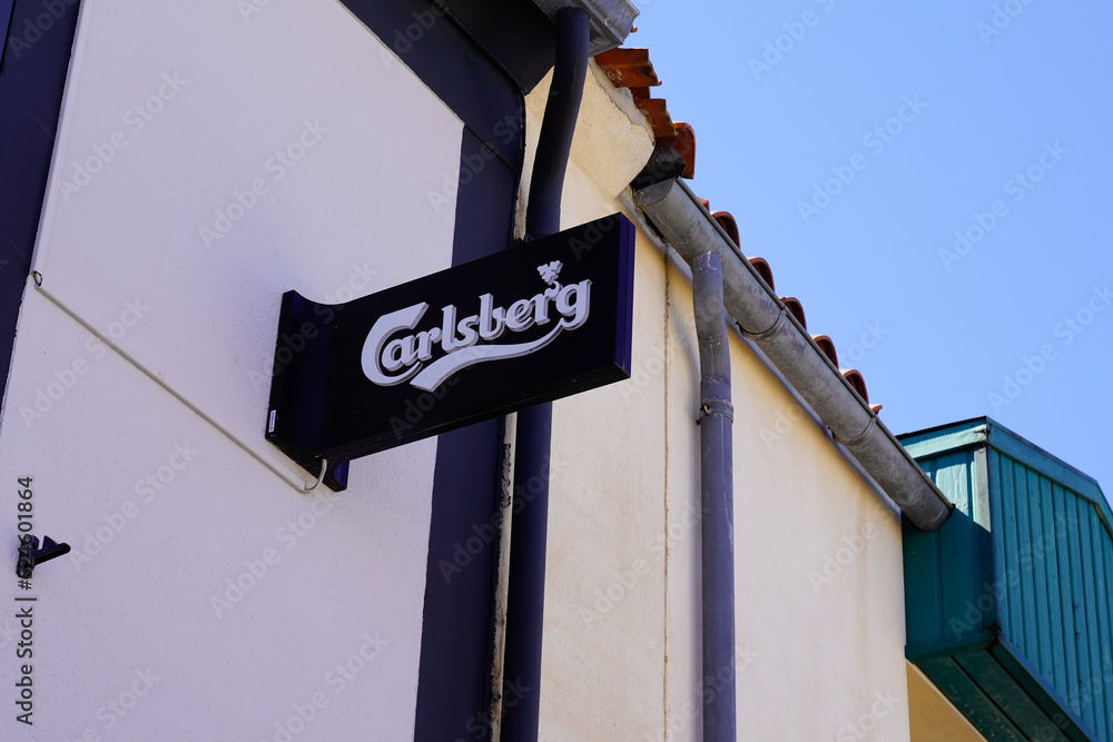 Carlsberg text brand and sign logo wall facade of beer bar restaurant ...