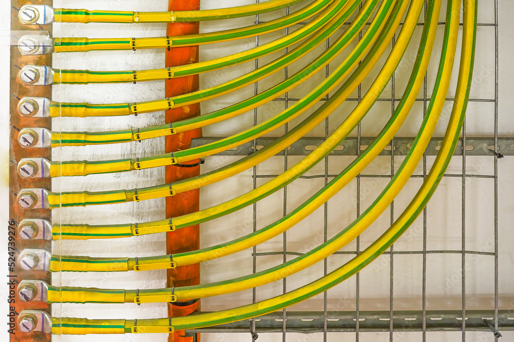 Electrical high voltage ground copper cables on wall. Grounding ...