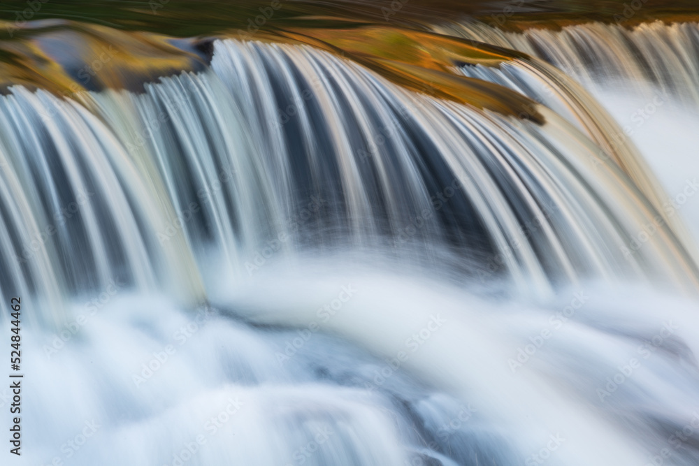 Landscape of a cascade at Bond Falls captured with motion blur and ...