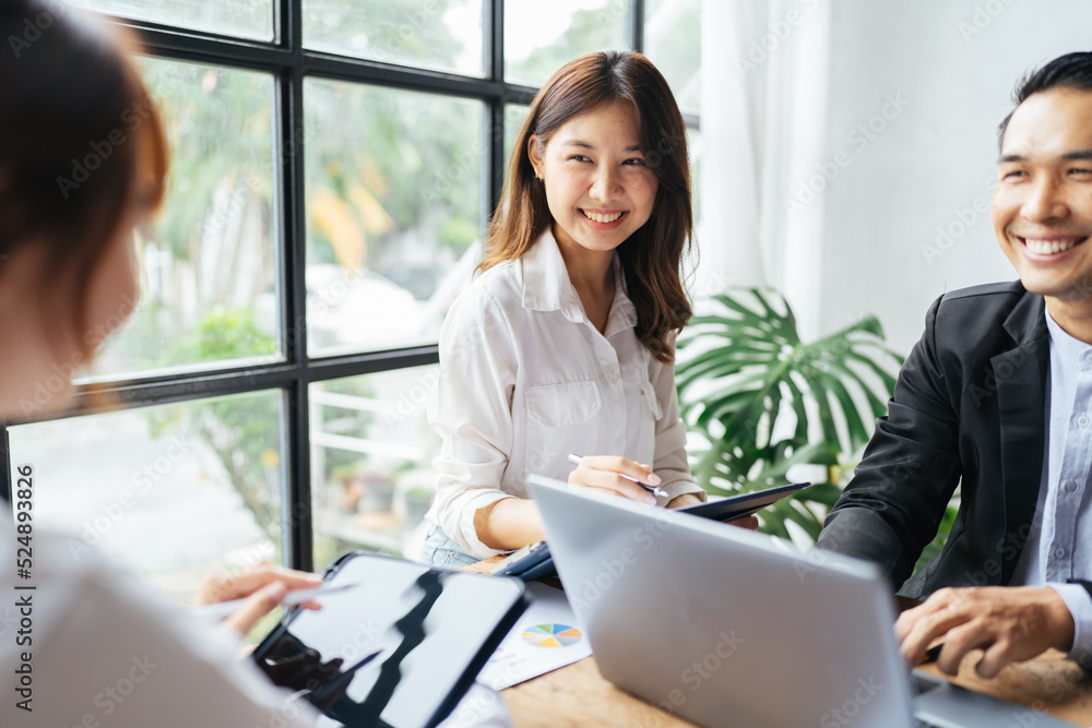 Asian business woman present and explain work to female colleague ...