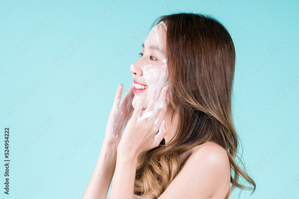 Wash and scrub on face of Happy charming Asian woman applying facial ...