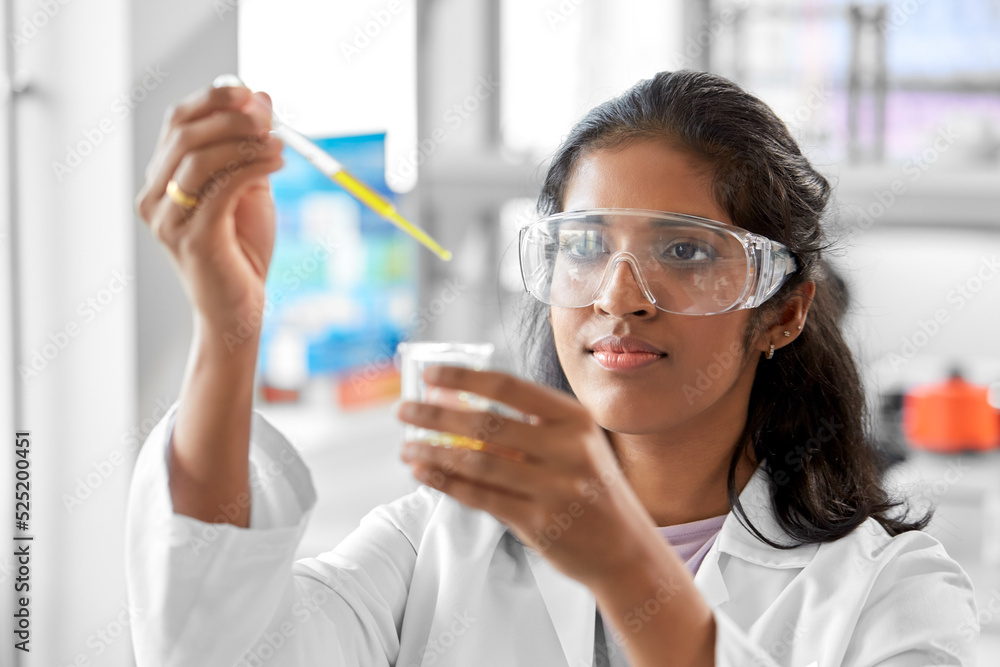 science research, work and people concept - female scientist in goggles ...