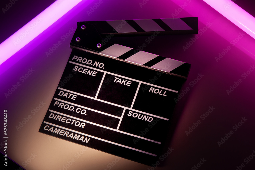 Clapperboard movie slate on Glowing neon lighting background. video ...