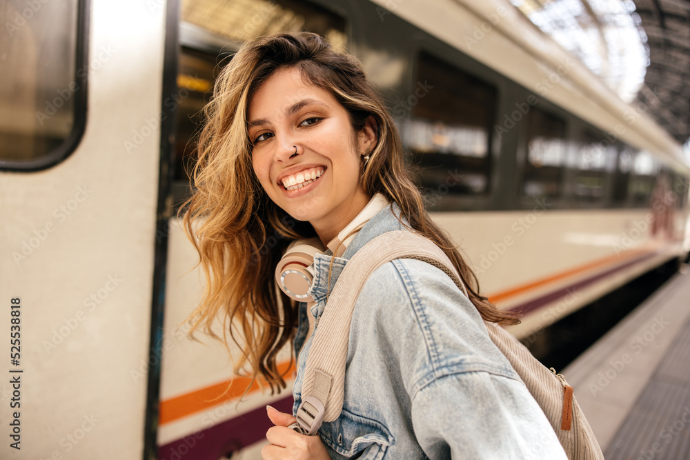Positive young caucasian woman smiles with her teeth at camera, going ...