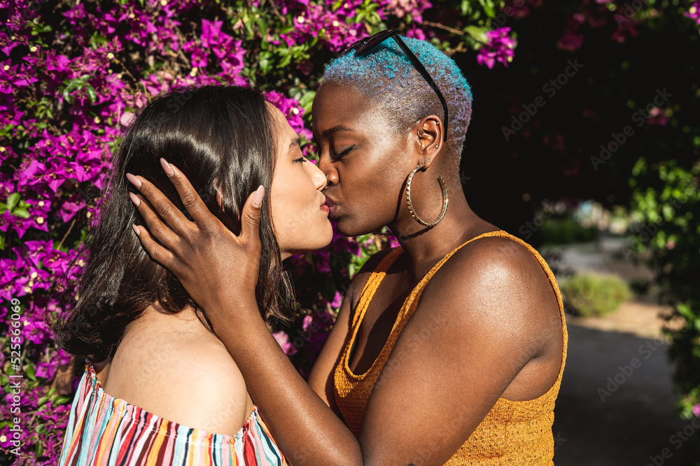 Multi ethnic lesbian couple kissing outdoors Stock Photo | Adobe Stock